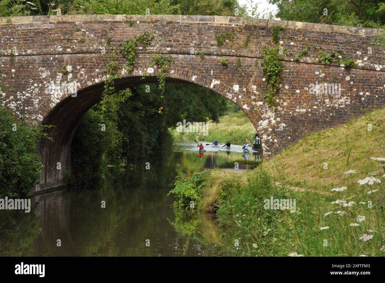 Canoeing on the Kennet and Avon canal going under a arch bridge in ...