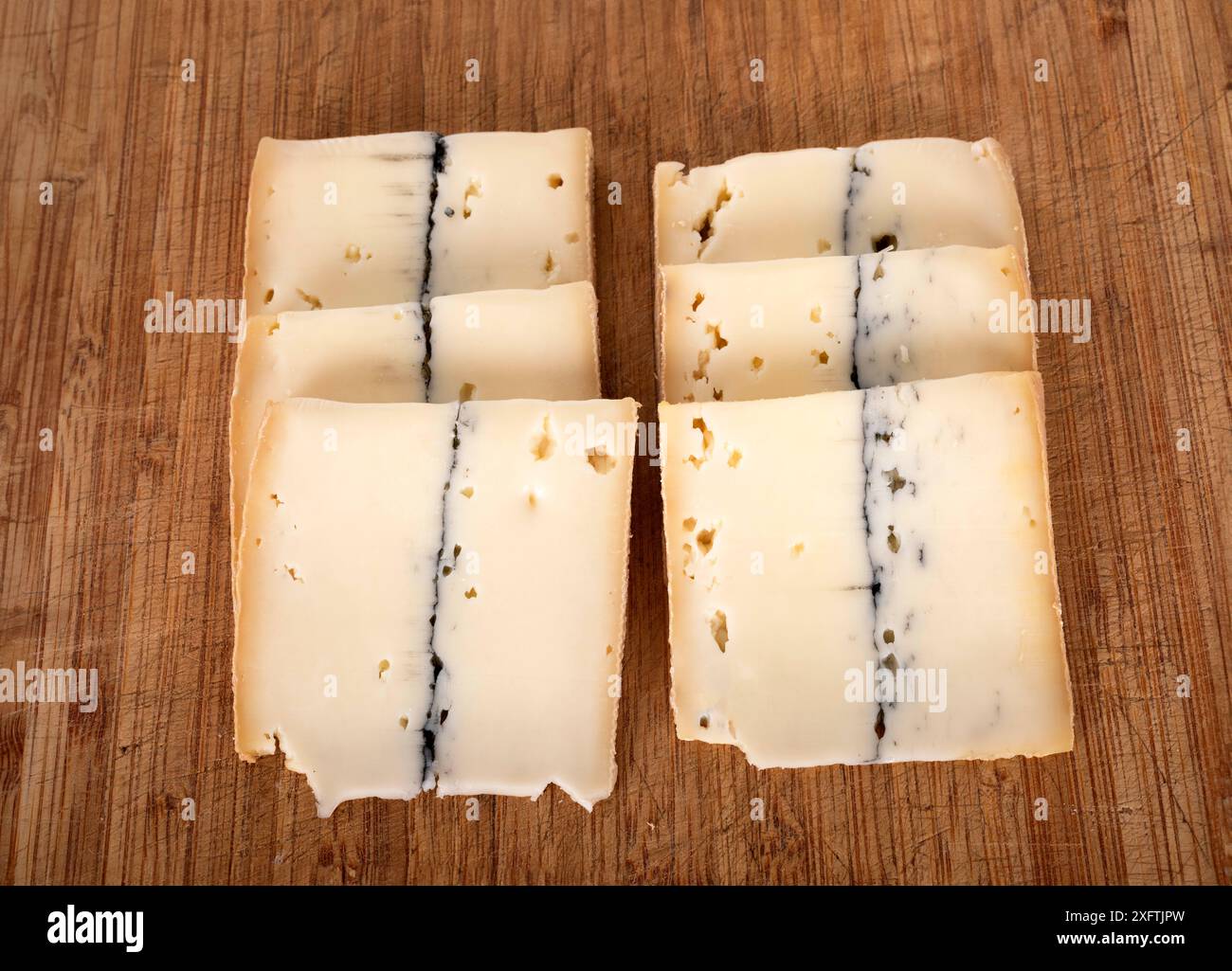 morbier cheese in front of wood background Stock Photo - Alamy