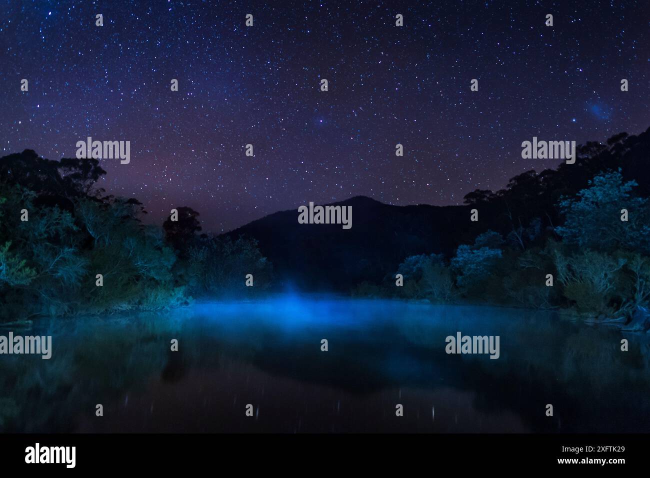 Winter evening fog rises above a slow moving section of the Mitta Mitta ...