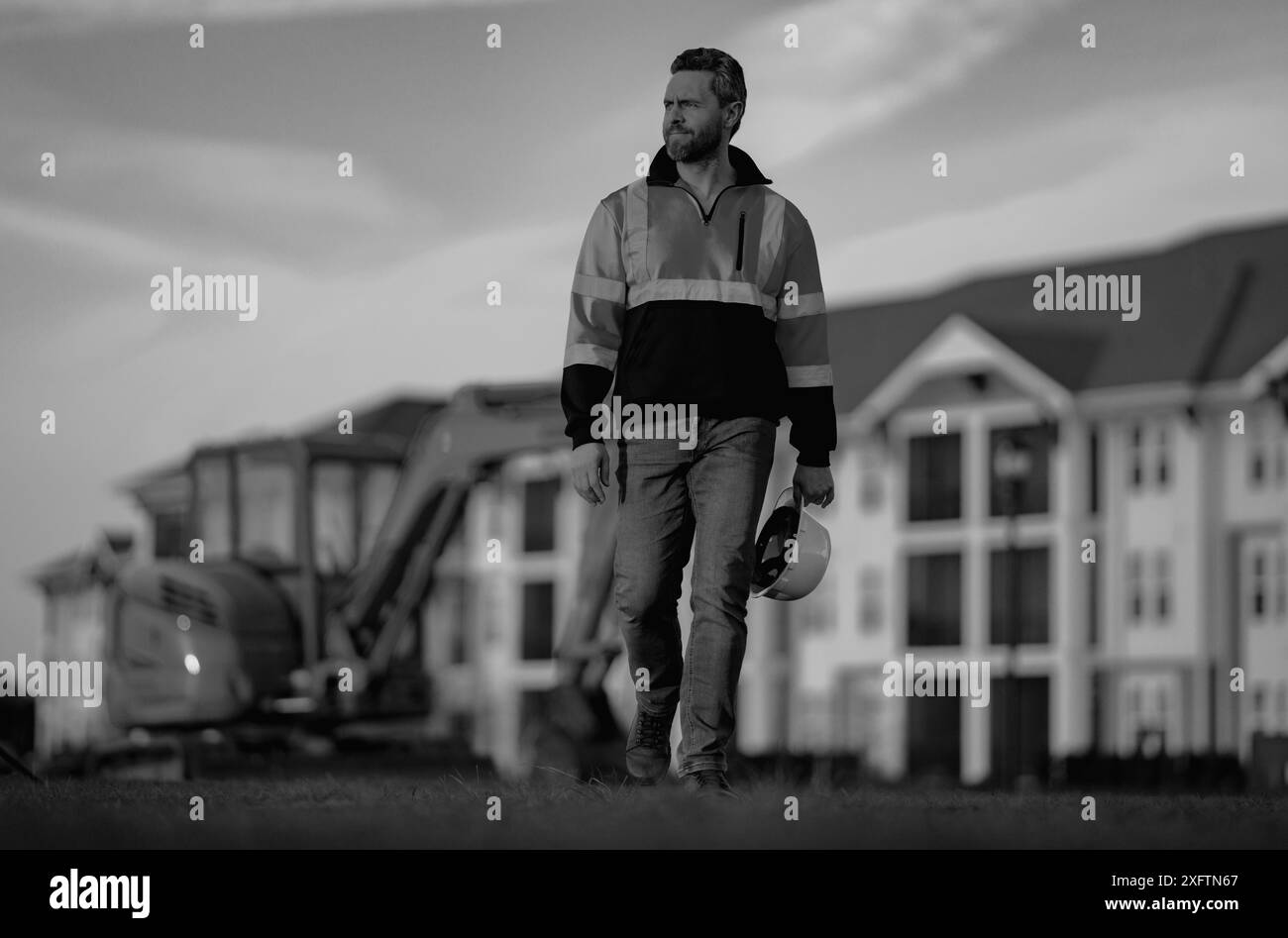 Builder in a construction site. Builder with excavator ready to build ...
