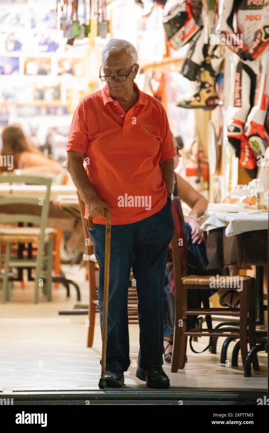 Elderly man with cane exiting restaurant, classic dining experience ...