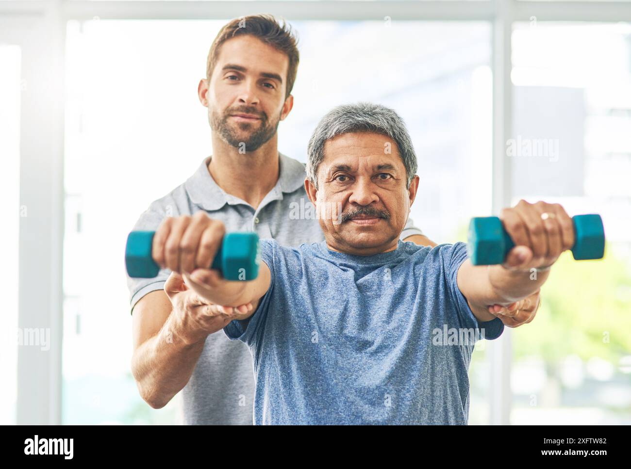 Elderly man, workout and dumbbell with physiotherapist for ...