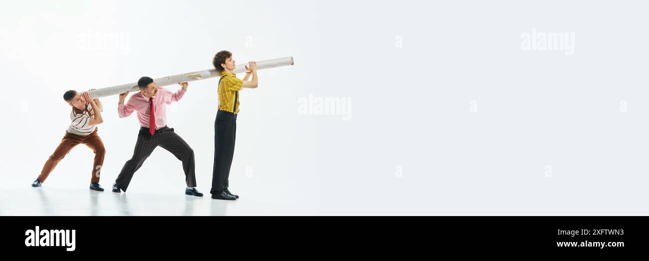 Three man in retro-style clothes carrying giant tube together isolated ...