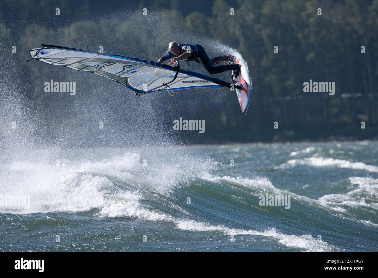 Windsurfer jumping waves Stock Photo - Alamy