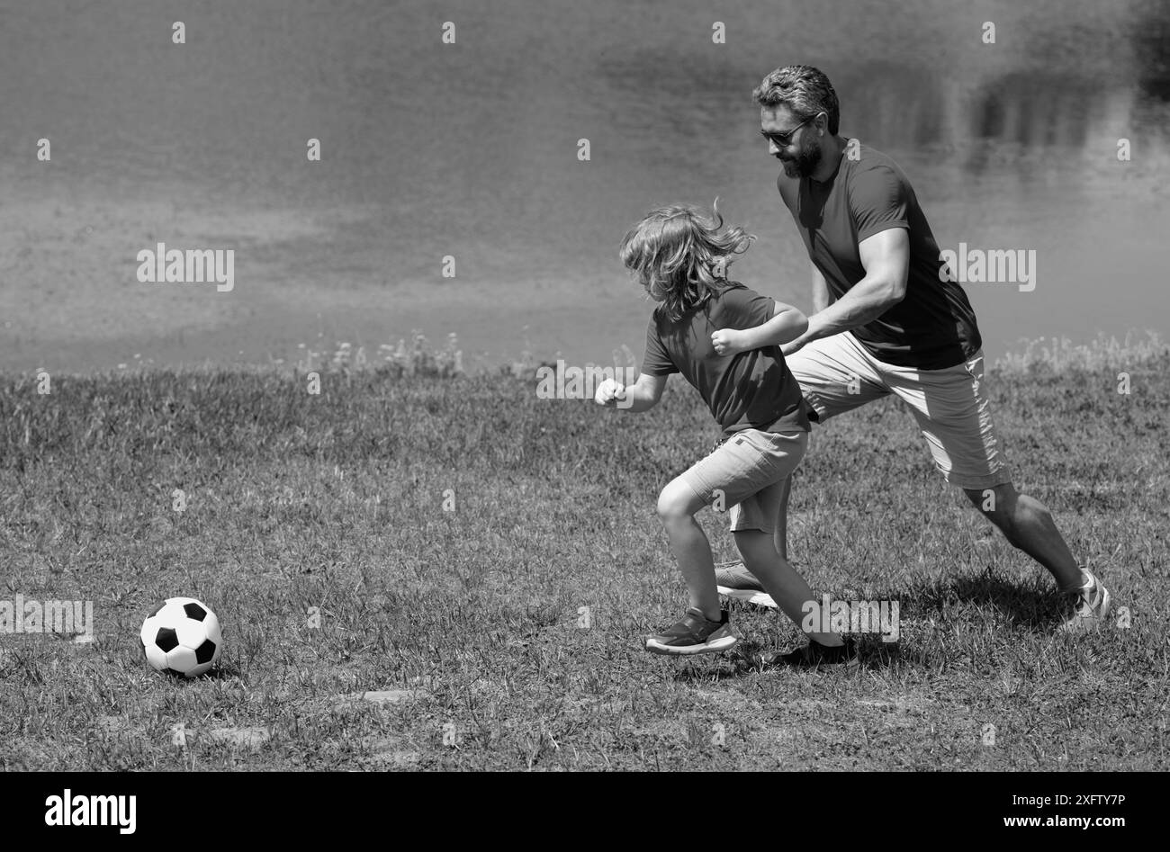 Father and son playing football together. Dad with kid spend hours ...