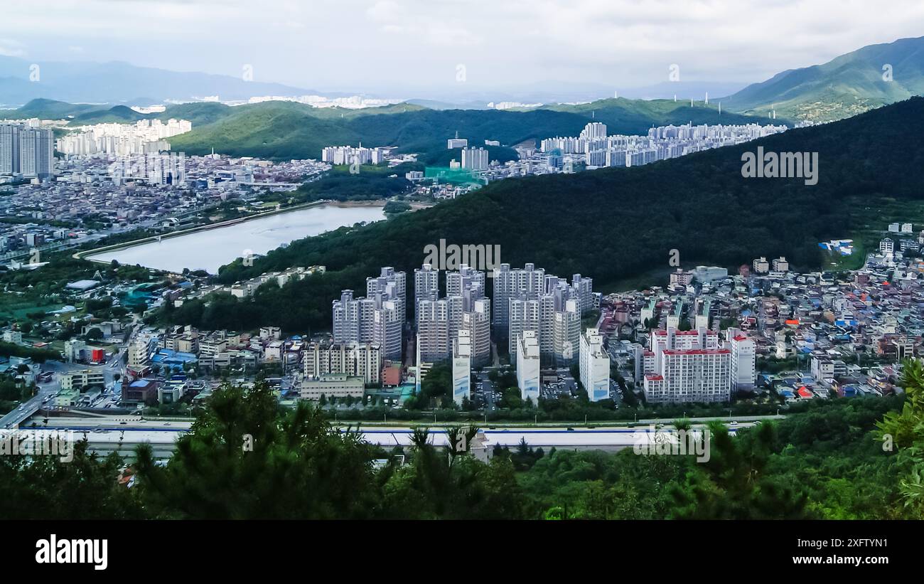 Aerial view of a Korean city with high-rise buildings andmountains ...