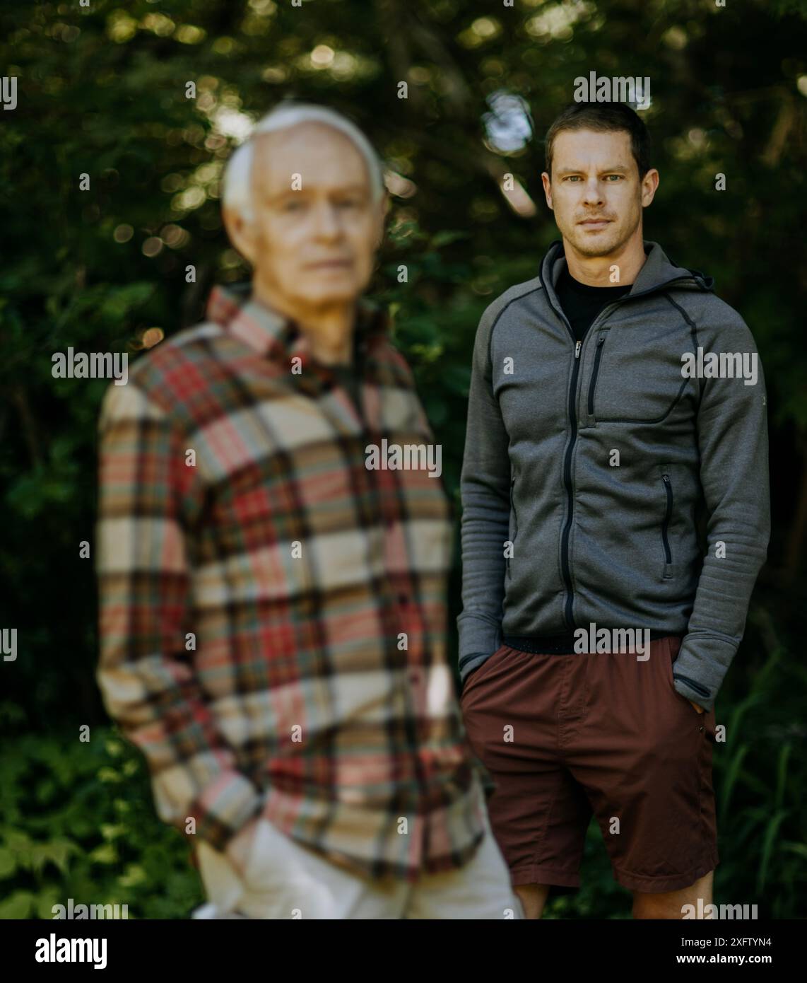 young 30's man poses for portrait with his elderly 70's father Stock ...