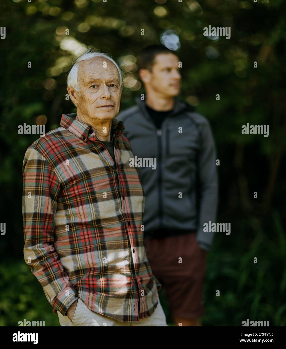 Elderly baby boomer man poses for portrait with middle aged son Stock ...