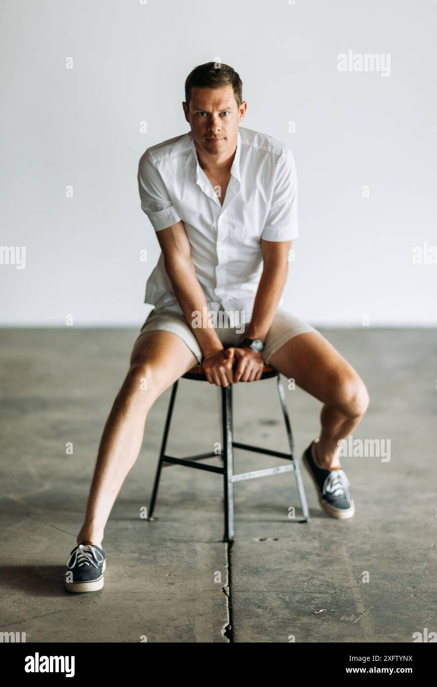 39 year old male in white shirt and shorts poses for portrait Stock ...