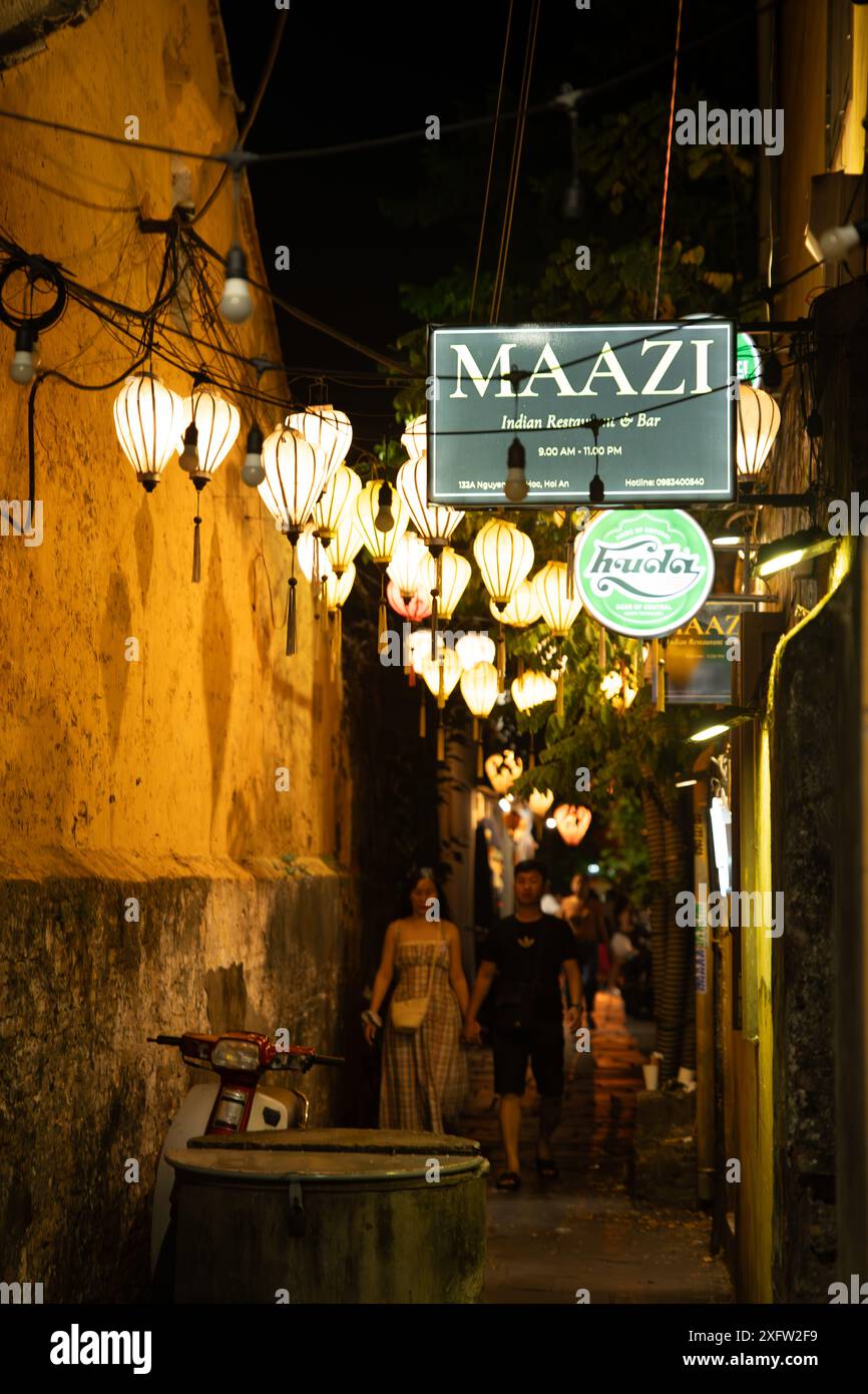 View of the street in Hoi An ancient town at night with lantern boats ...