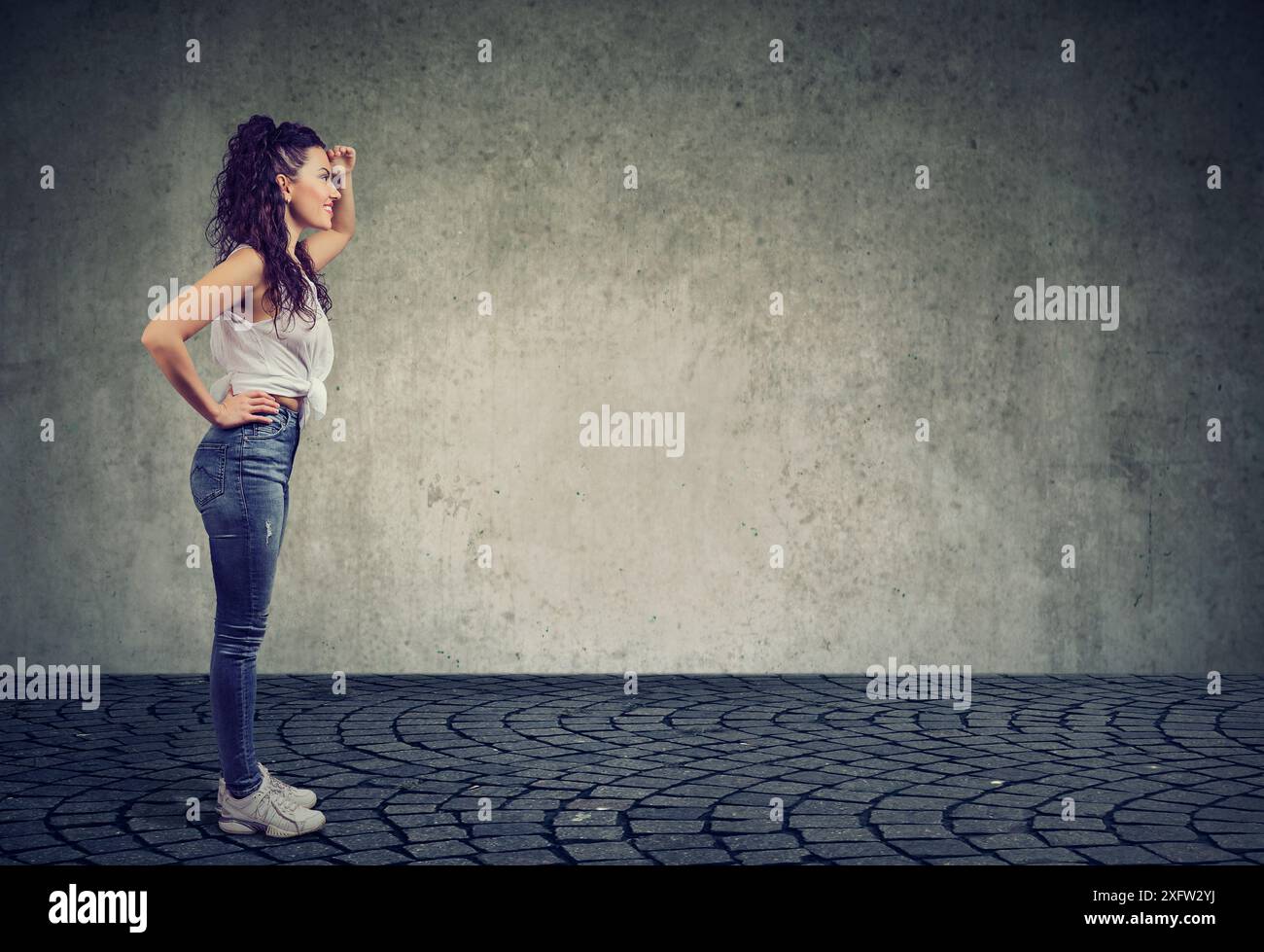 Side view of a young woman with hand at forehead looking far away Stock ...