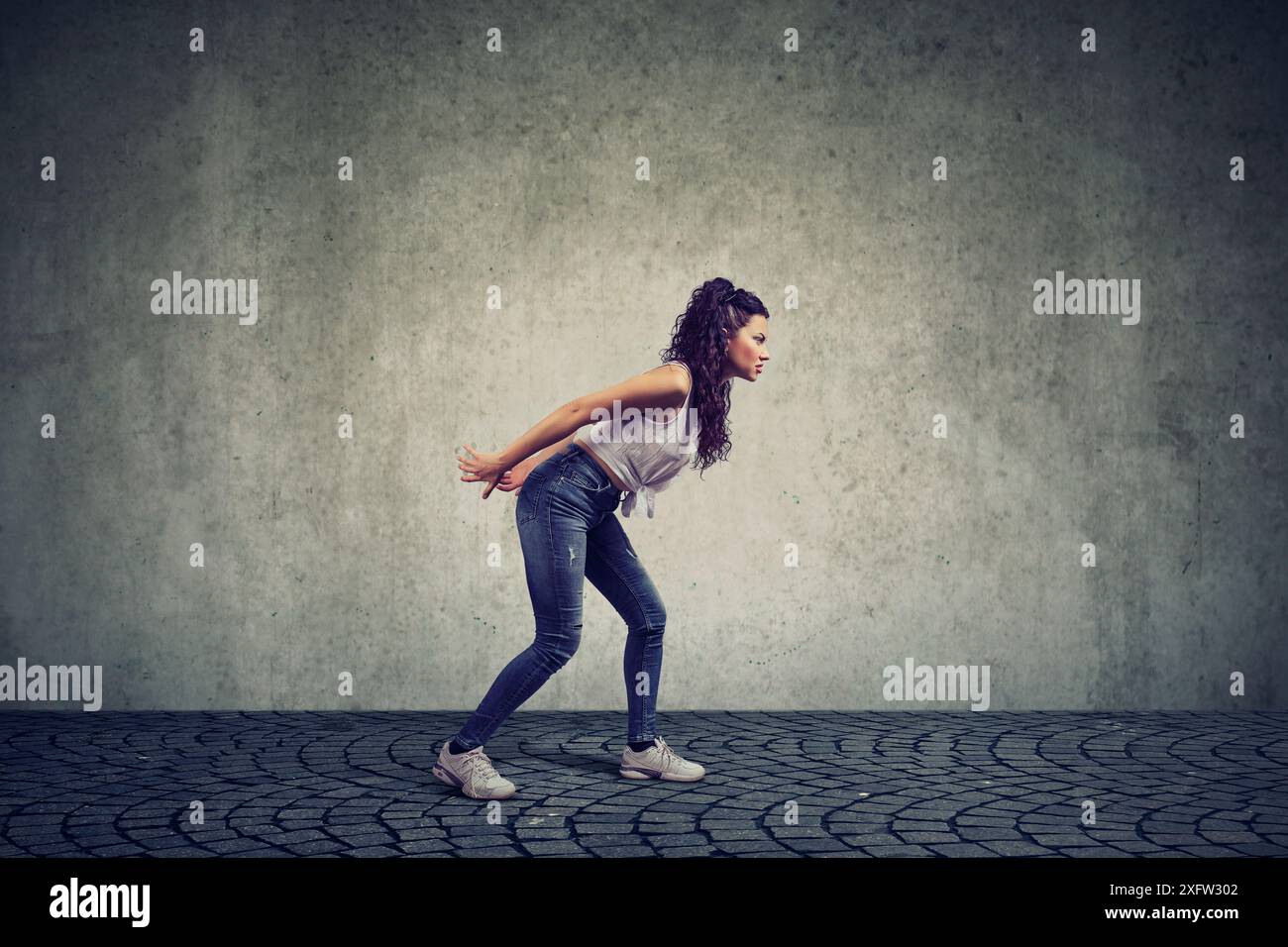 Young woman bending over under imaginary burden and difficulties Stock ...