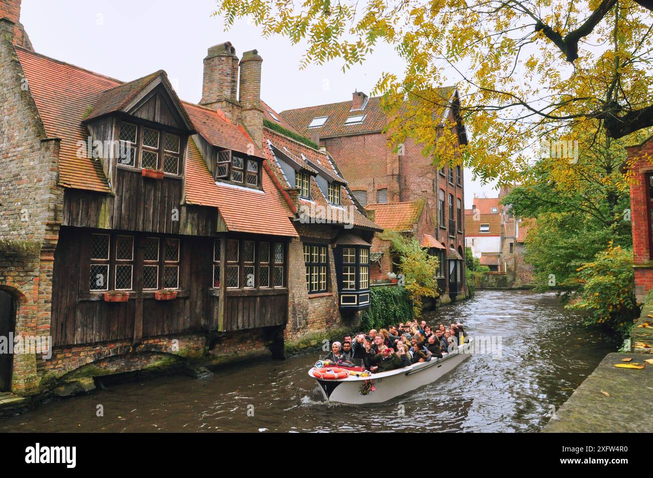 30-10-2014 Brussels, Belgium - Tourists enjoy a boat ride along Bruges ...