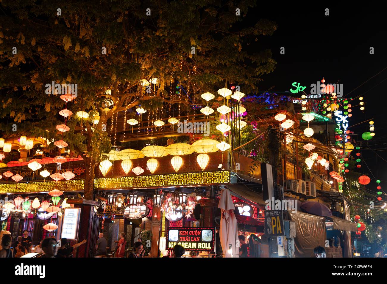View of the street in Hoi An ancient town at night with lantern boats ...