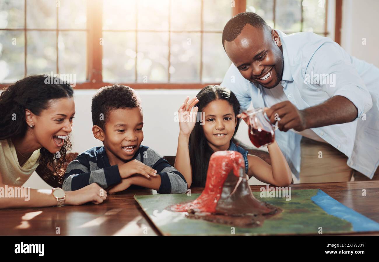 Science, parents and children with volcano in home for school project ...
