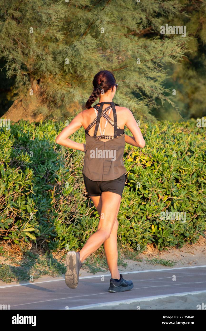 Urban jogging scene with middle-aged woman running Stock Photo - Alamy
