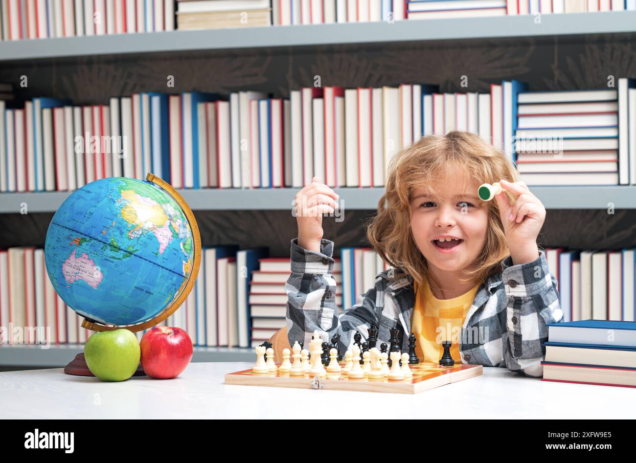 Kid play chess at school. Child think about chess game. Intelligent ...