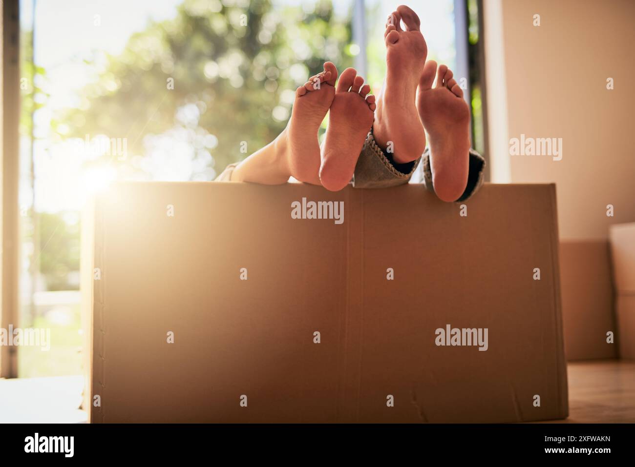 Boxes, feet and moving for couple in home, floor and relax for new ...