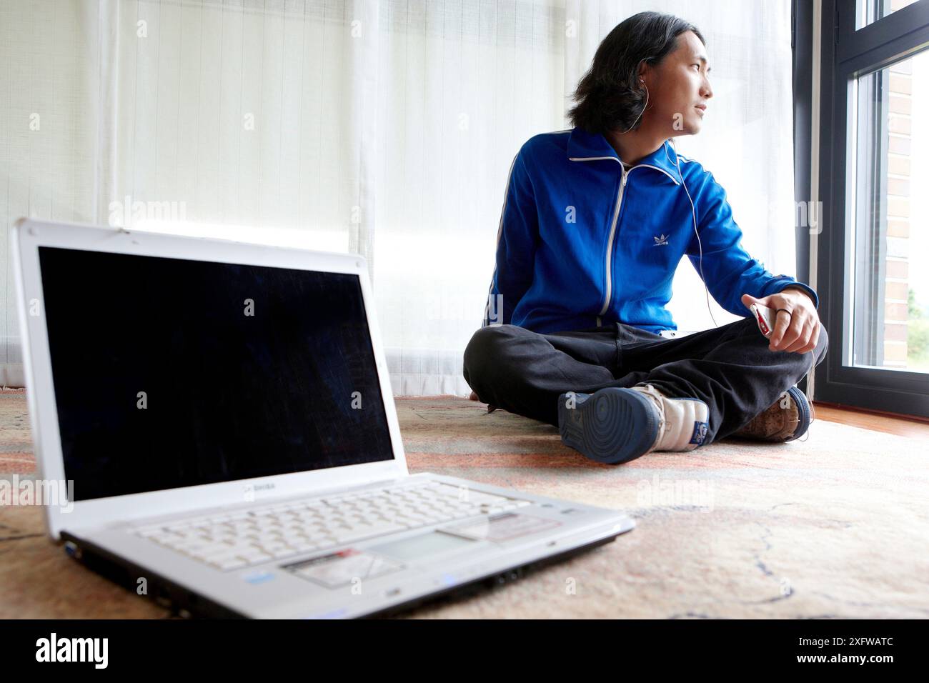 Young Japanese man with laptop computer in room Stock Photo - Alamy