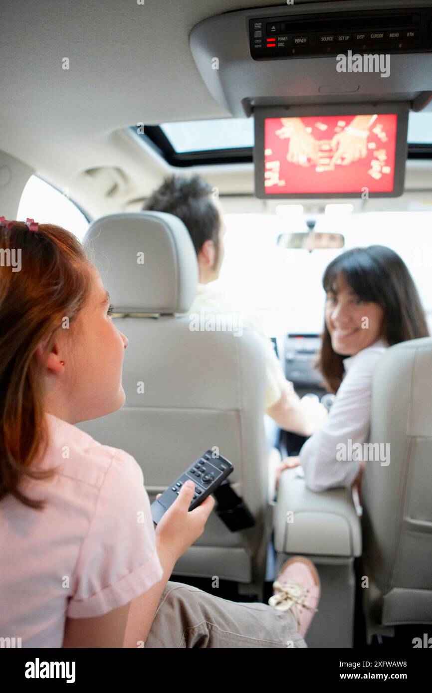 Family travelling, girl watching DVD in car Stock Photo - Alamy