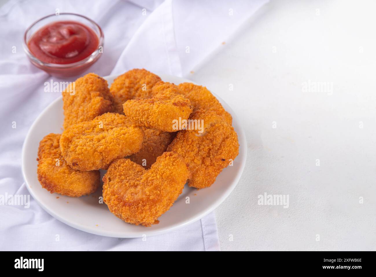 Traditional golden fresh fried chicken nuggets on a plate, with ketchup ...