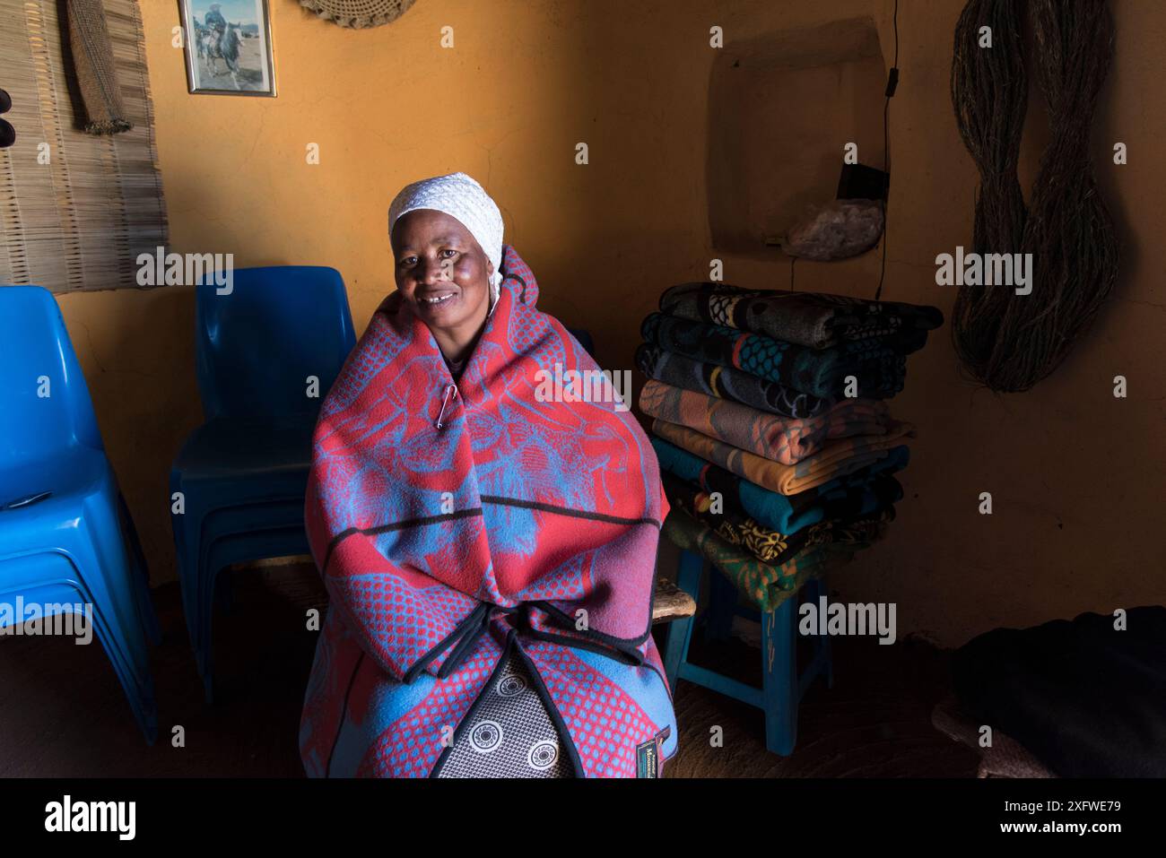 Local woman wrapped in traditional Basotho blanket in her home in ...