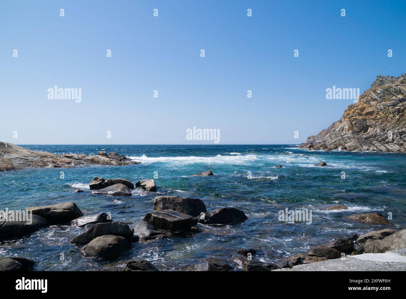 Pretty coastal scene in the Cies Islands with rugged rocks, crystal ...