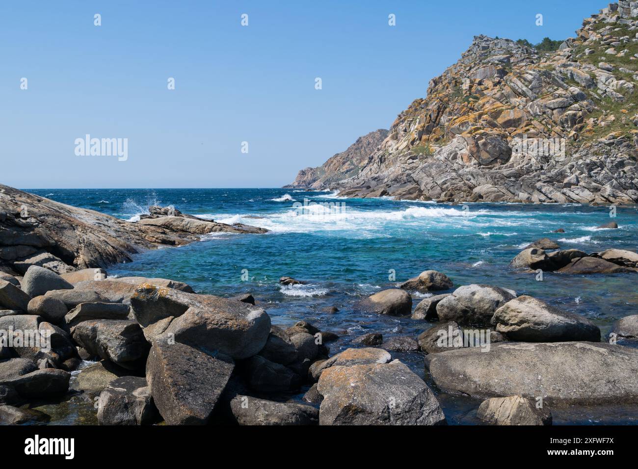 Pretty coastal scene in the Cies Islands with rugged rocks, crystal ...