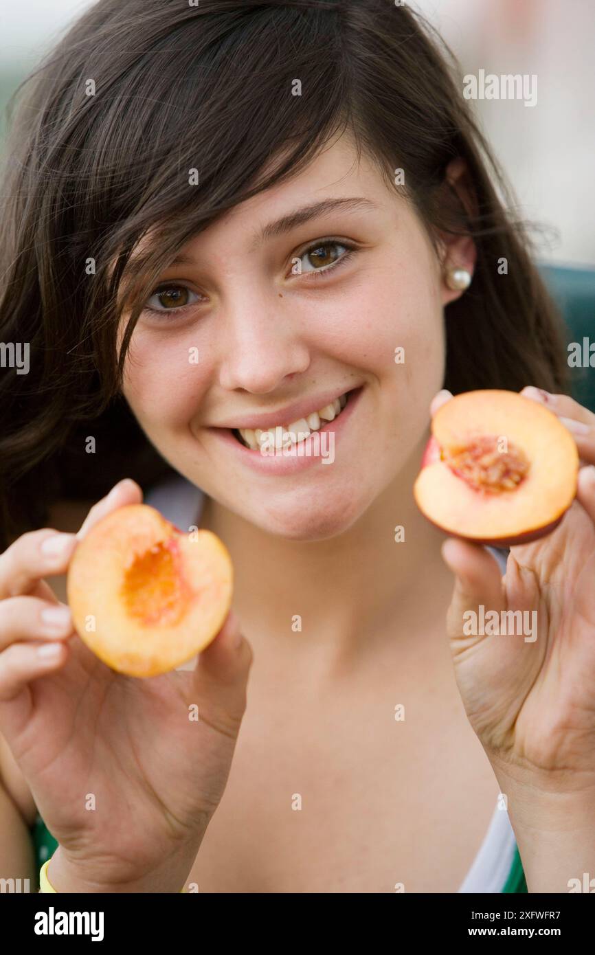 Seventeen year old girl eating fruit Stock Photo - Alamy