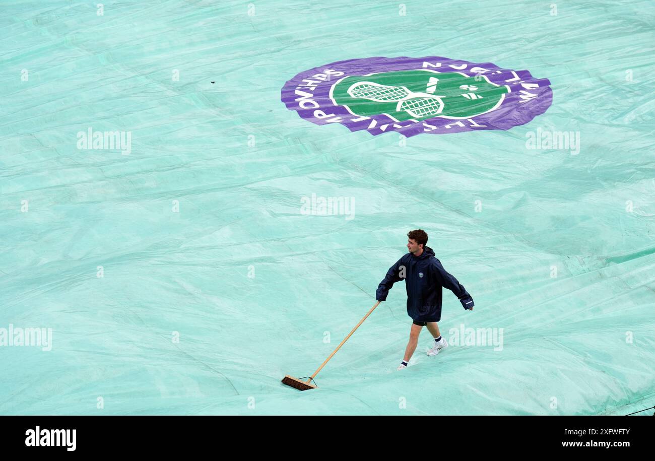 Ground staff sweep water off hi-res stock photography and images - Alamy