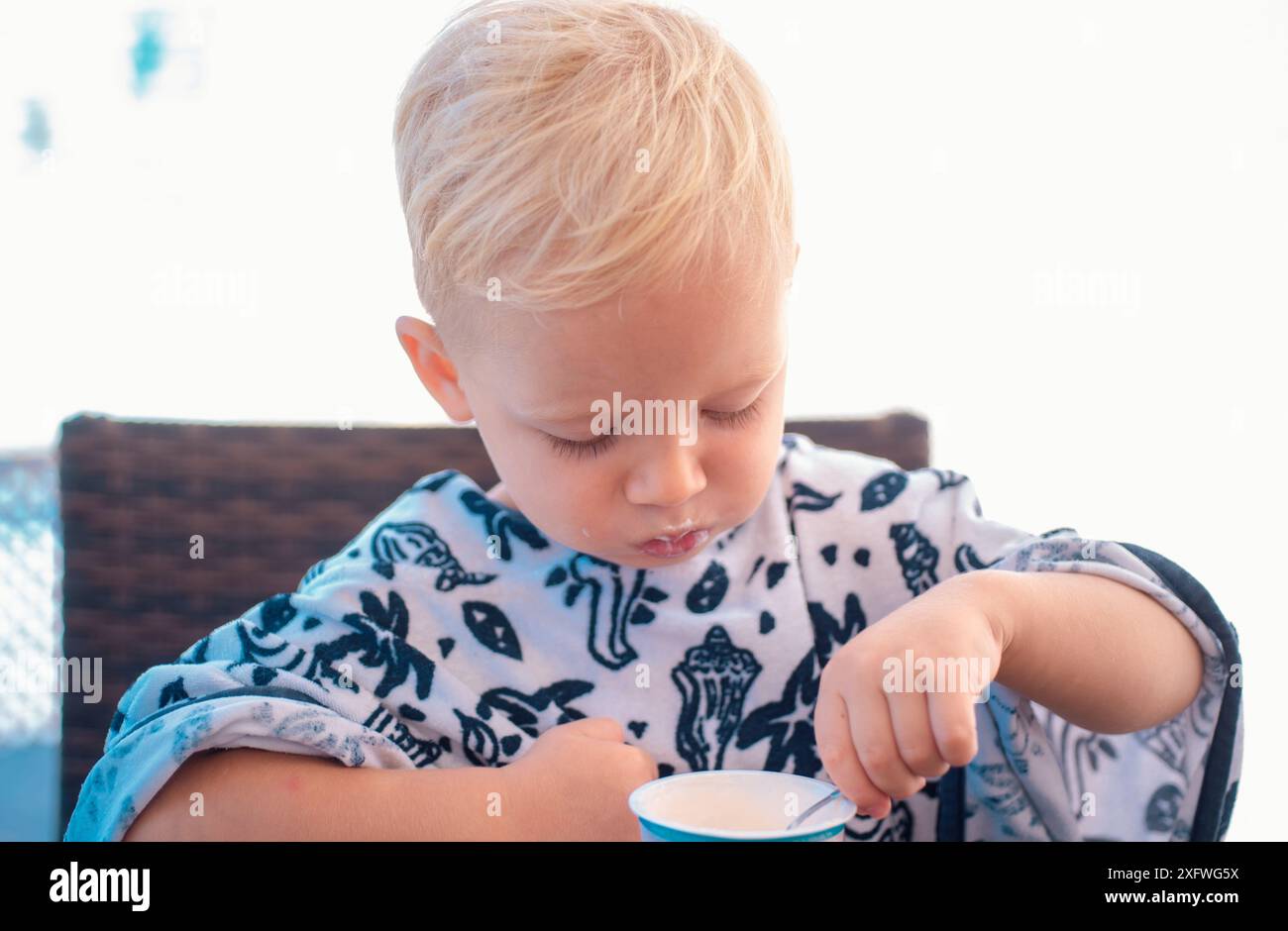 Baby food, babies eating. Little boy eating yogurt Stock Photo - Alamy