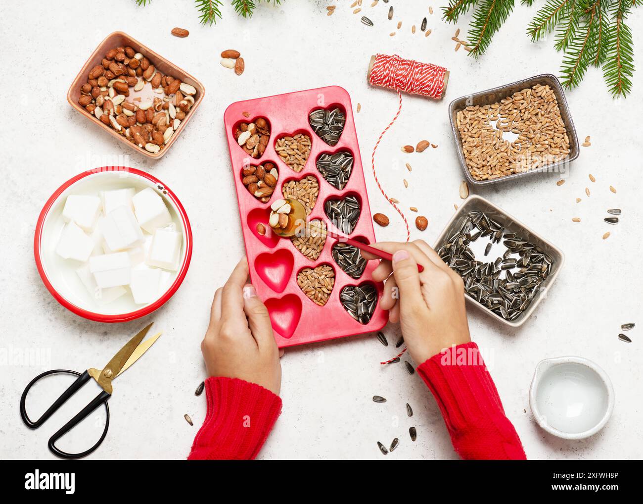 Step 3. Child filling the heart bar form with peanuts. Children ...