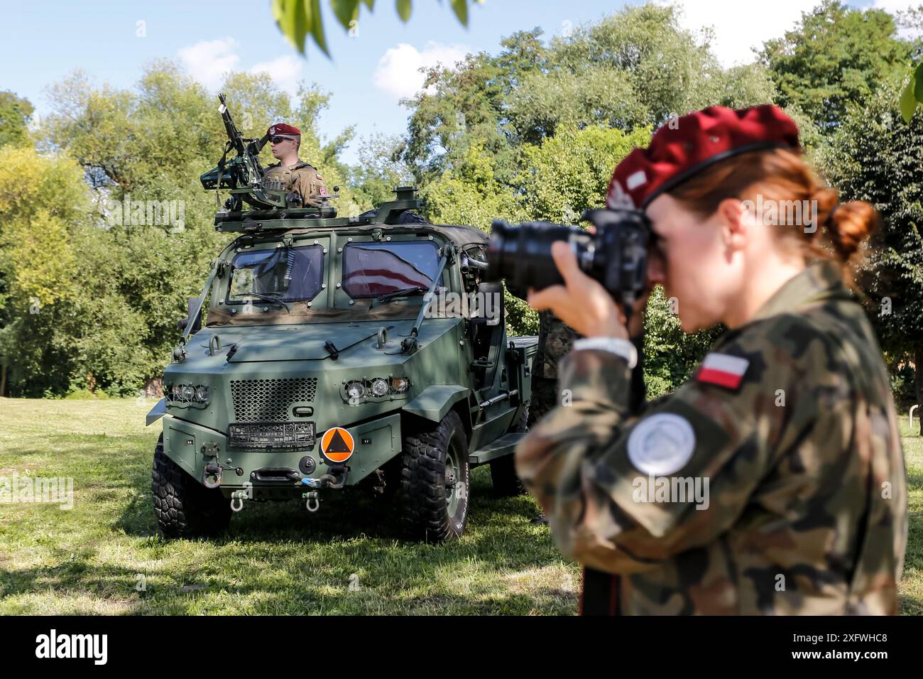 Servicemen stand in an armoured vehicle during the commencement ...