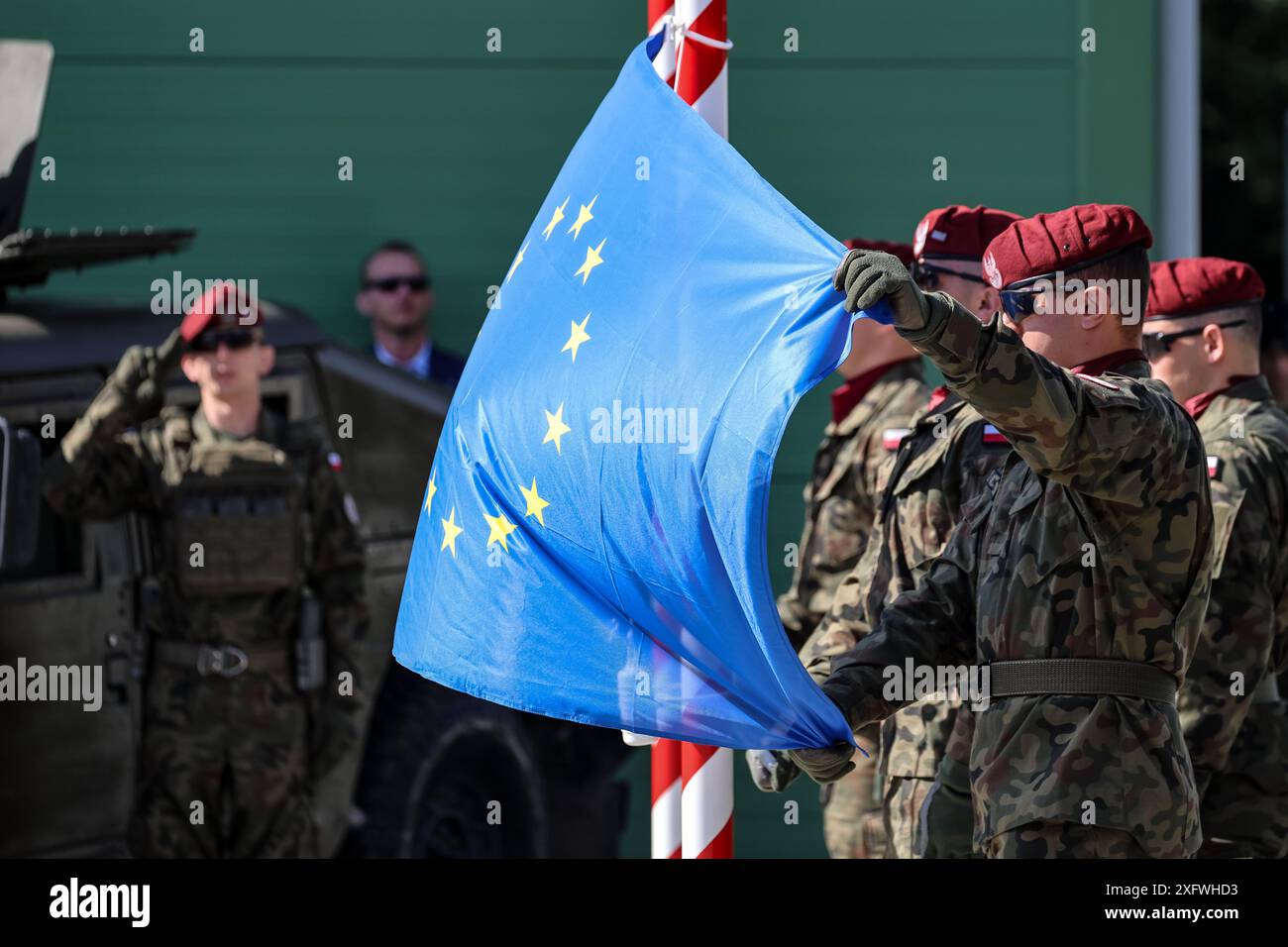 Servicemen hold European Union flag during commencement ceremony of the ...