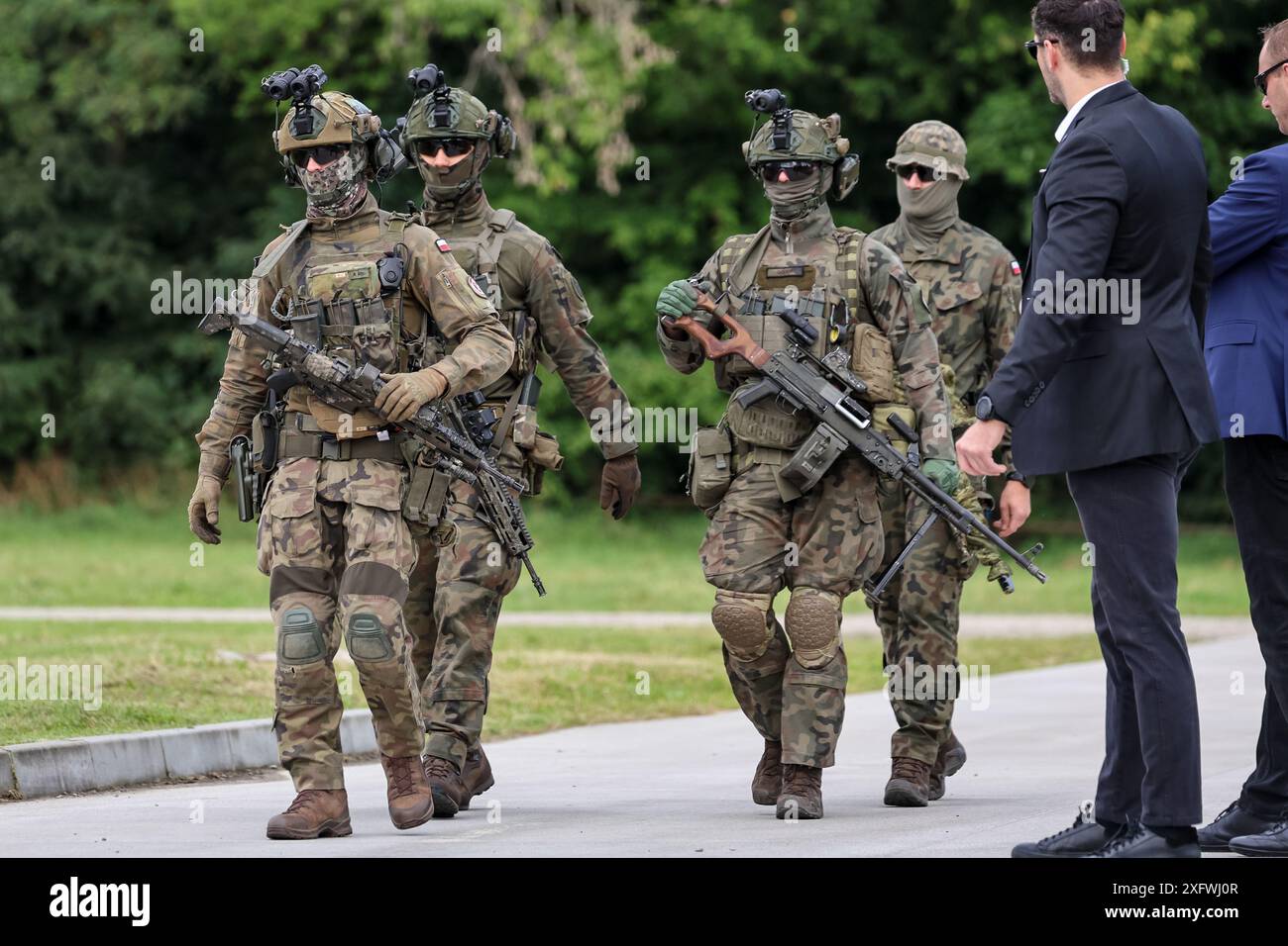 Servicemen march security men watch them during the commencement ...
