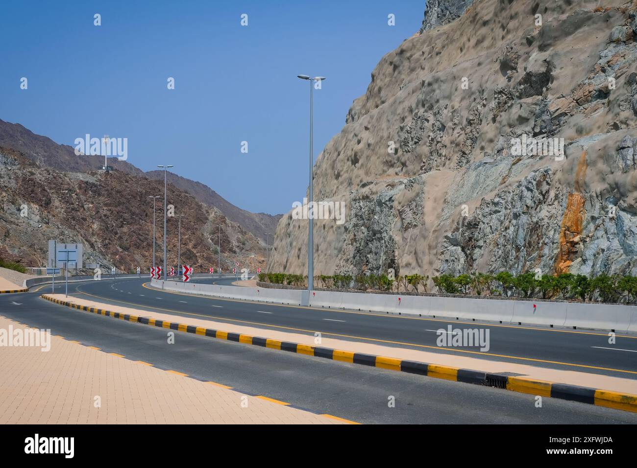 Empty perfect highway road in the Hajar Mountains landscape , the North ...