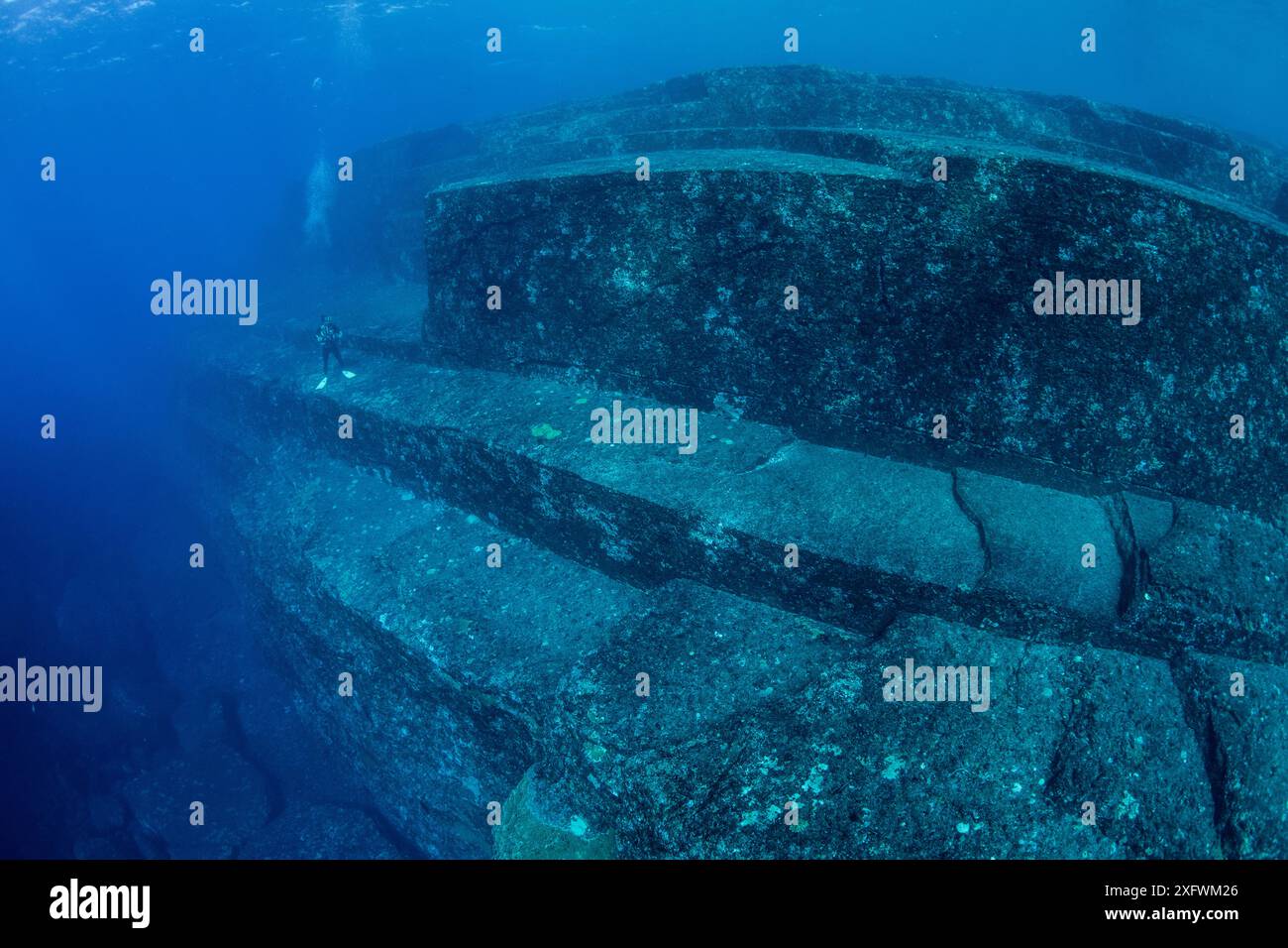 Scuba diver exploring the Yonaguni Monument, a submerged rock formation ...