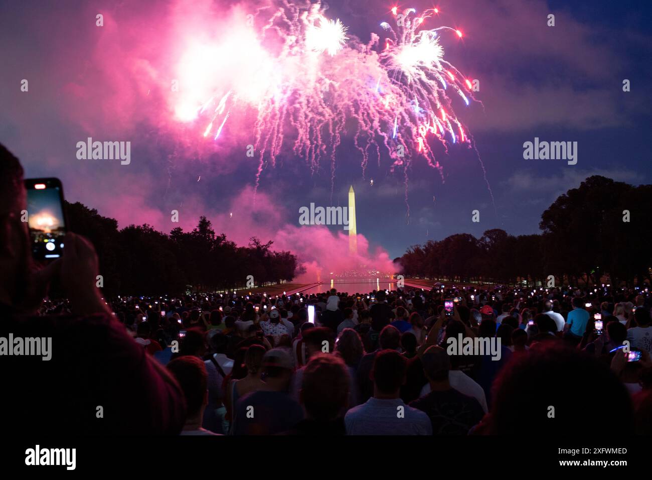 Attendees watch the Independence Day fireworks display along the ...