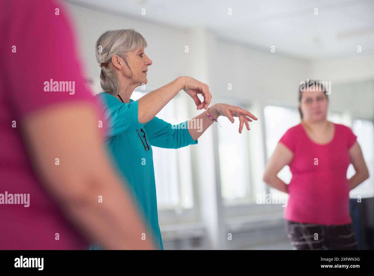 Female instructor explaining women at dance studio Stock Photo - Alamy