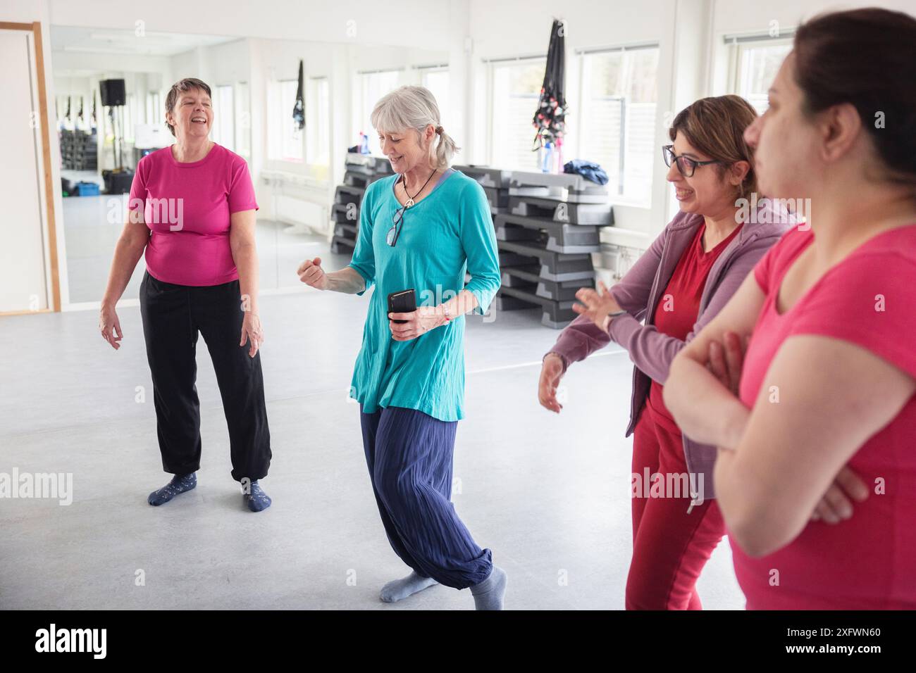 Female instructor dancing with students at studio Stock Photo - Alamy