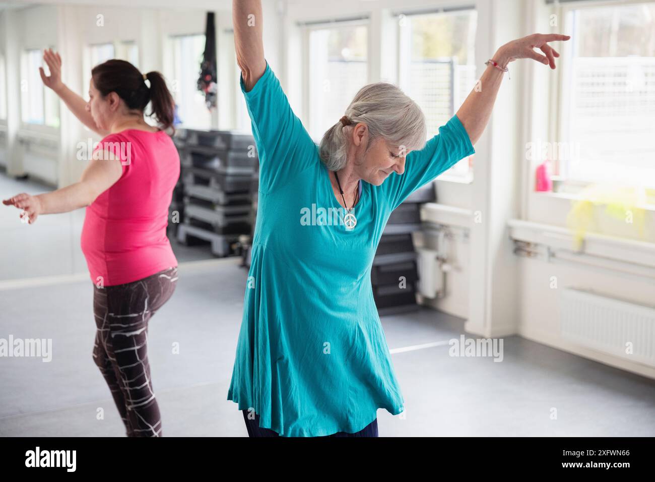 Female instructor dancing with student at studio Stock Photo - Alamy