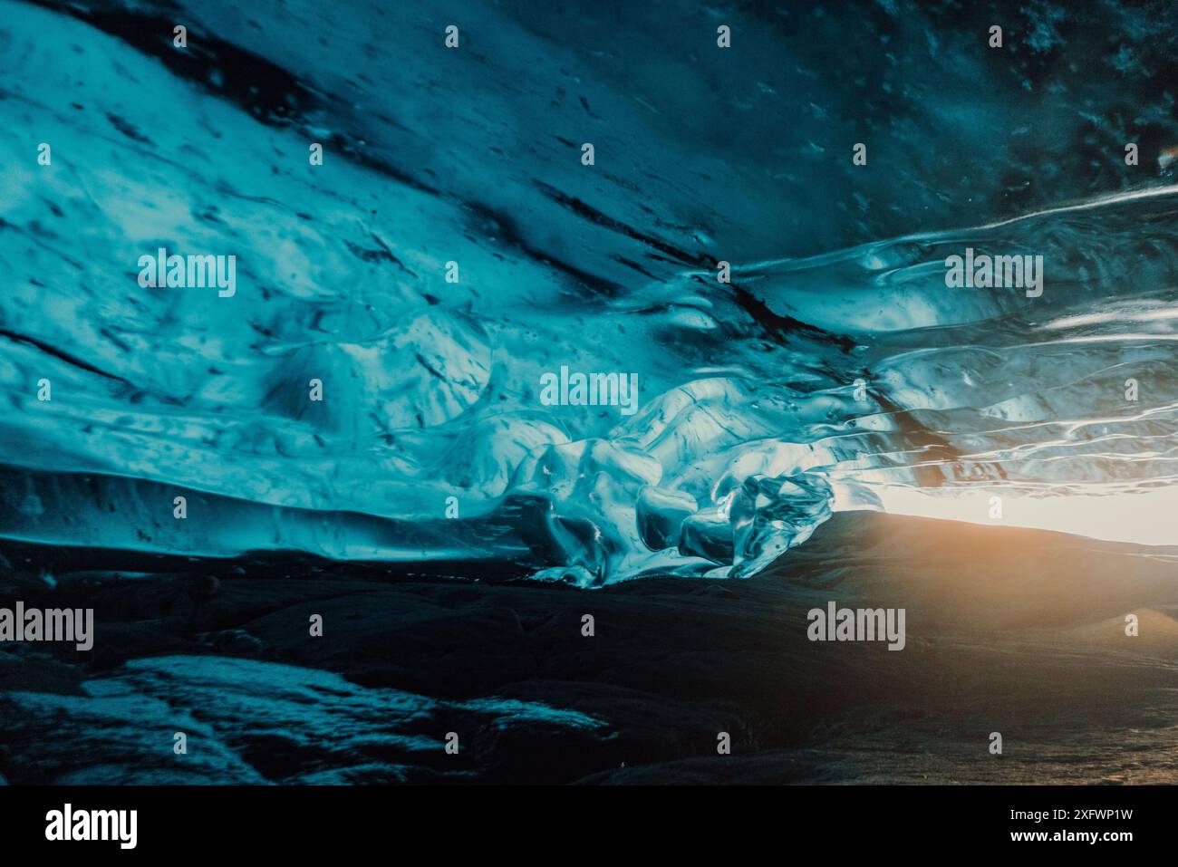 Interior of melting ice cave during sunset Stock Photo - Alamy