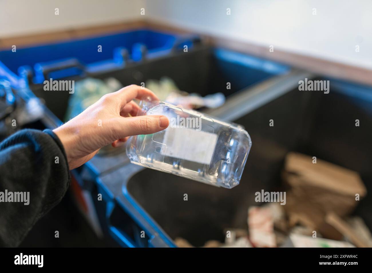 Hand of person trashing plastic container in bin Stock Photo - Alamy