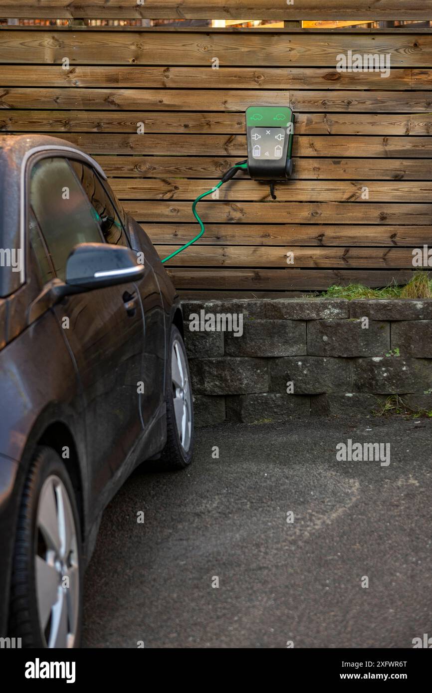 Vehicle getting charged at electric charging station Stock Photo - Alamy