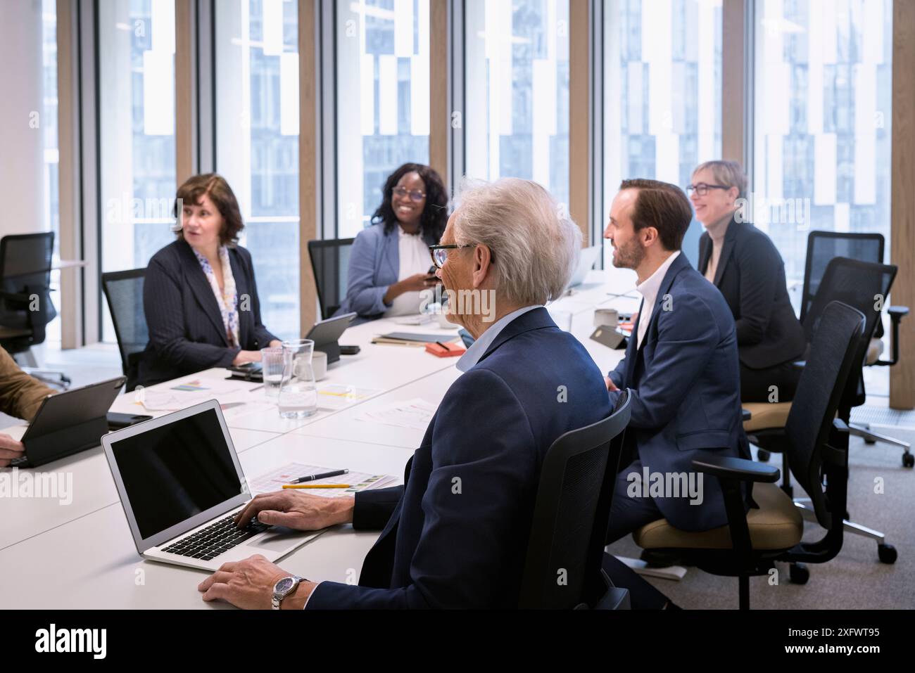 Multiracial group of business people talking while working in office ...