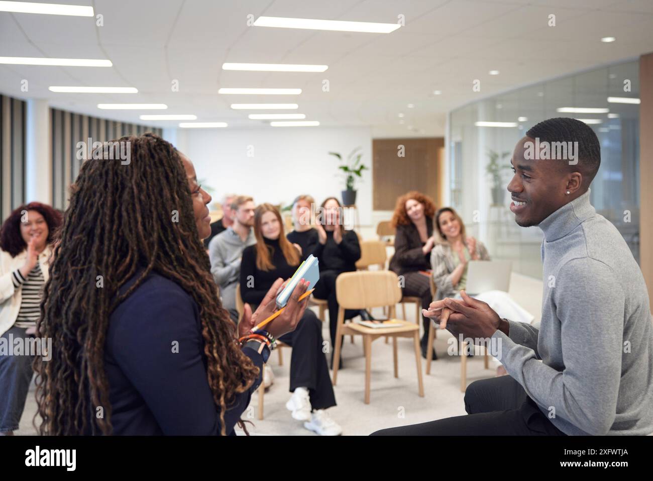 Multiracial corporate colleagues applauding for achievements in office ...