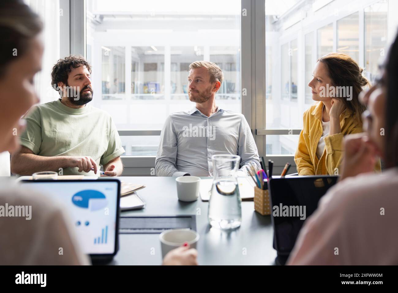 Corporate colleagues discussing strategies during meeting in office ...