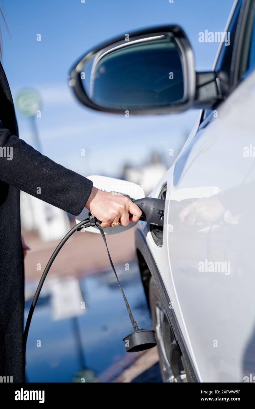 Female refilling gasoline in fuel storage tank Stock Photo - Alamy