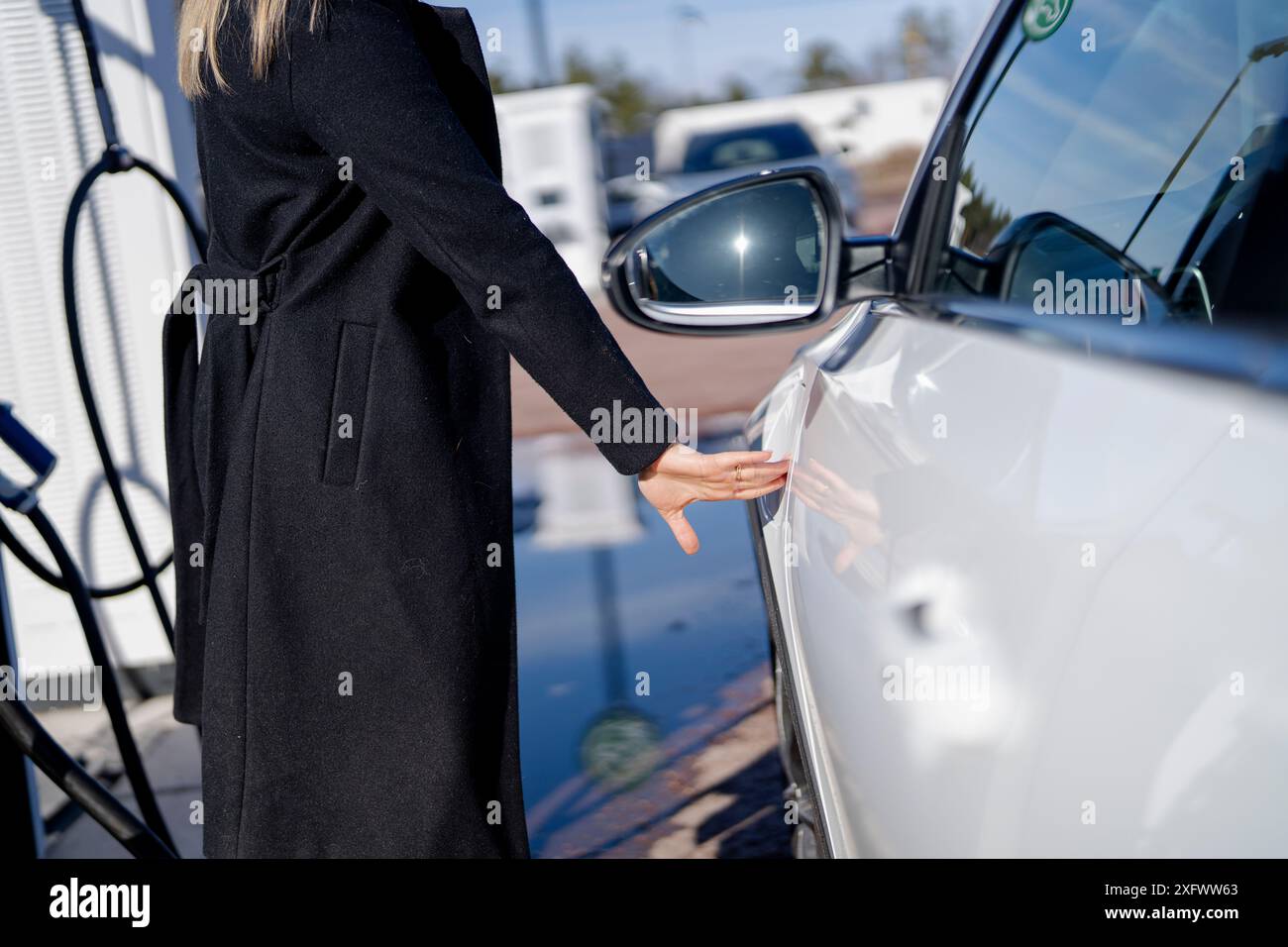 Hand of woman touching door of car Stock Photo - Alamy