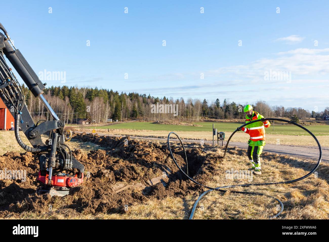 Maintenance engineer installing fiber optic cable at construction site ...